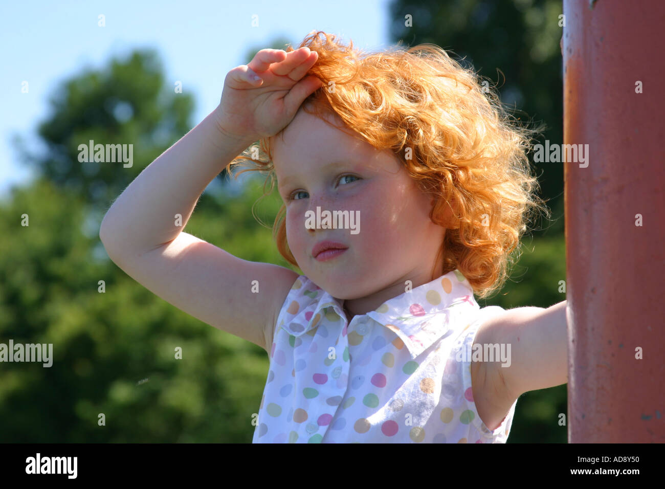 Young pretty redhead wiping sweat of her forehead Stock Photo - Alamy