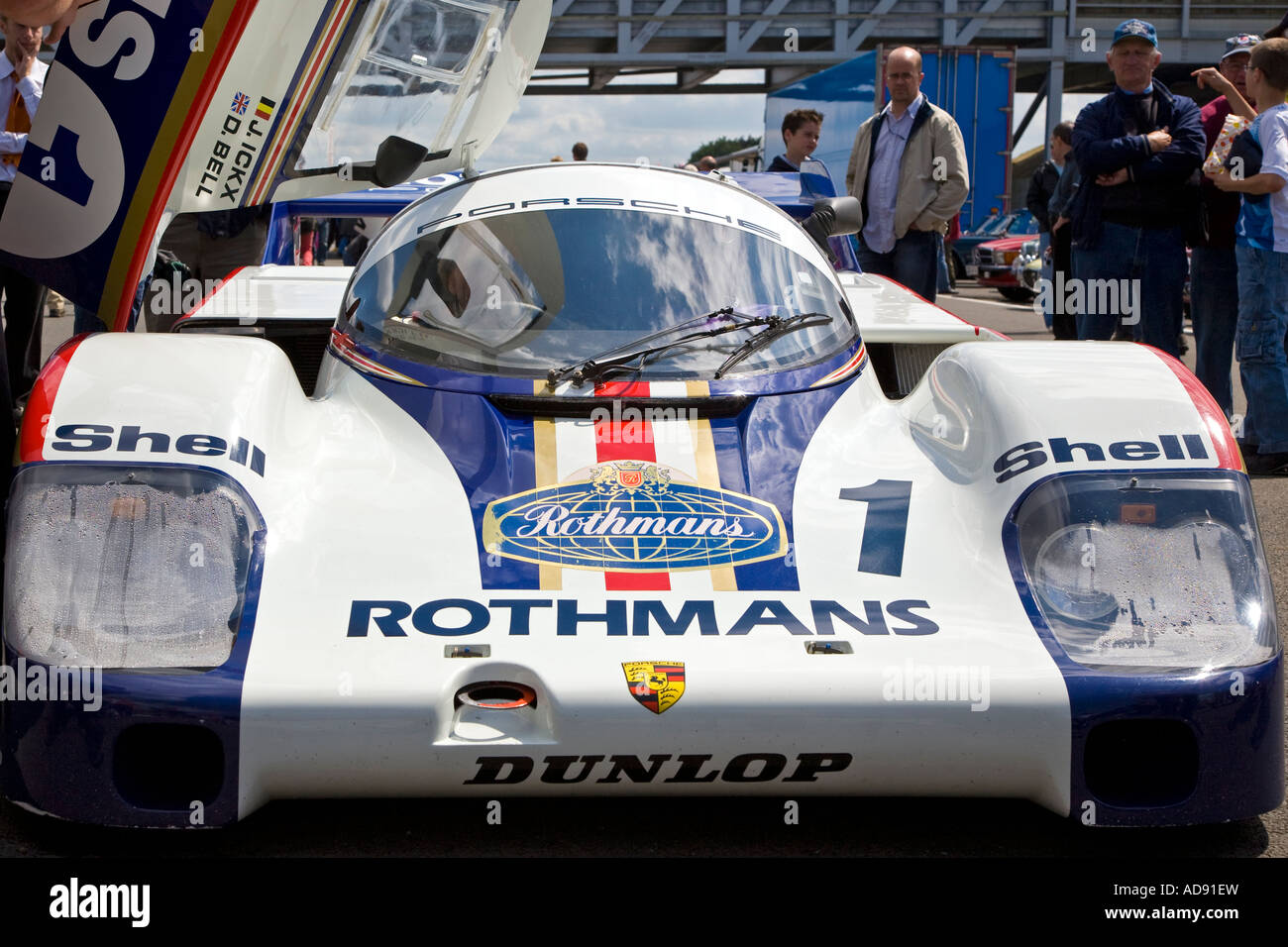Derek Bell waiting to display a classic Rothmans 956 Porsche race ...