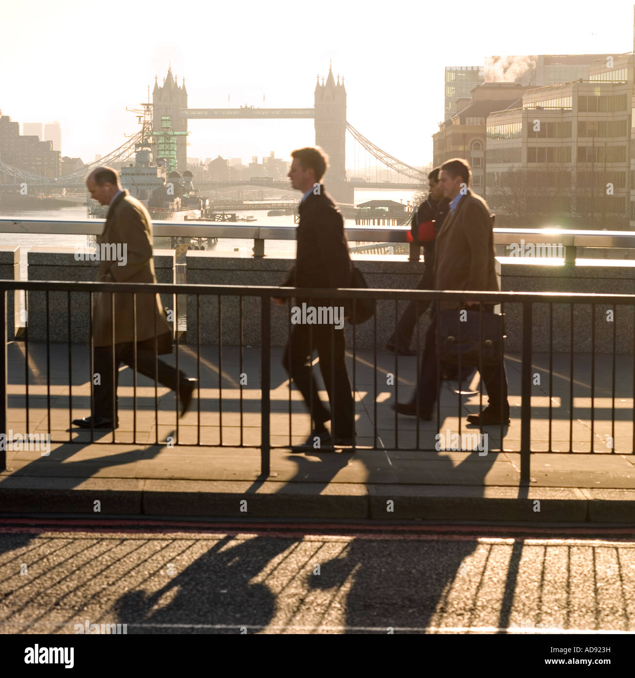 Going to work early morning office workers walking over London Bridge ...