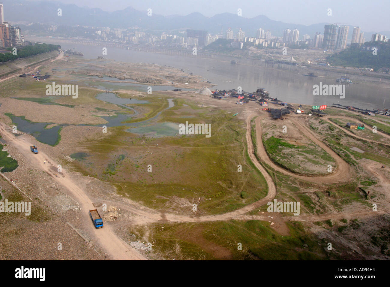 Trucks move along the exposed riverbed of the Yangtze River in ...