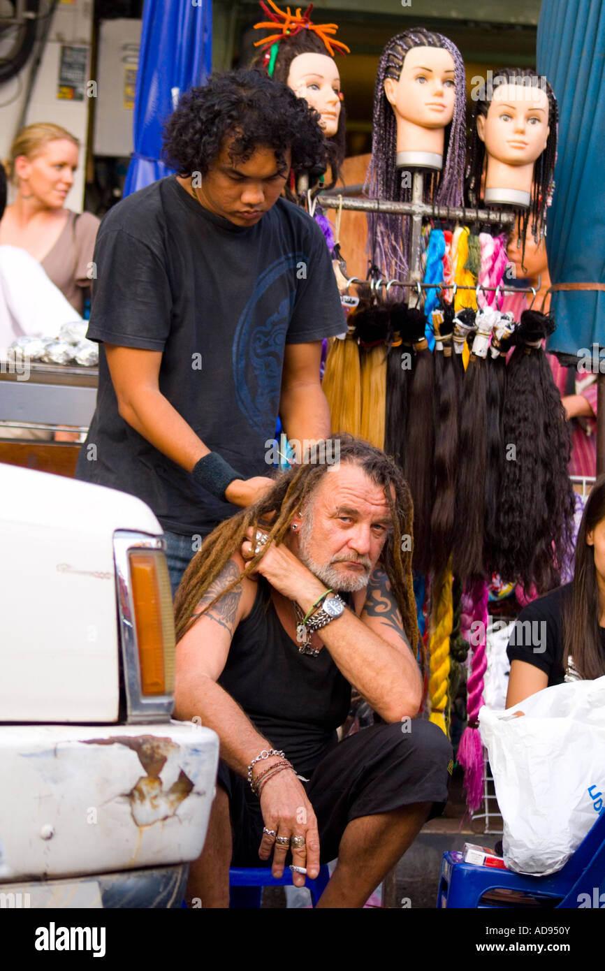 Traveler has hair braided, Khao San Road, Bangkok, Thailand Stock Photo ...