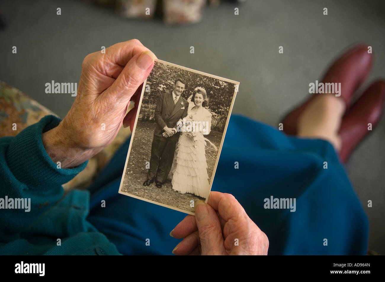 Elderly widow looks at photograph of herself and husband on their ...
