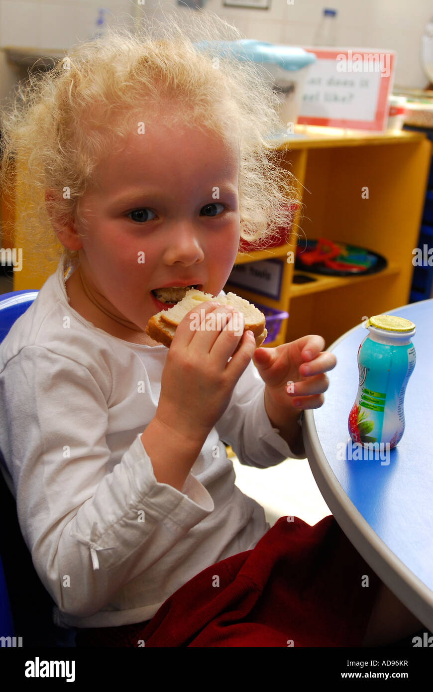 Primary school pupil eating her lunch at school Brentford UK Stock ...