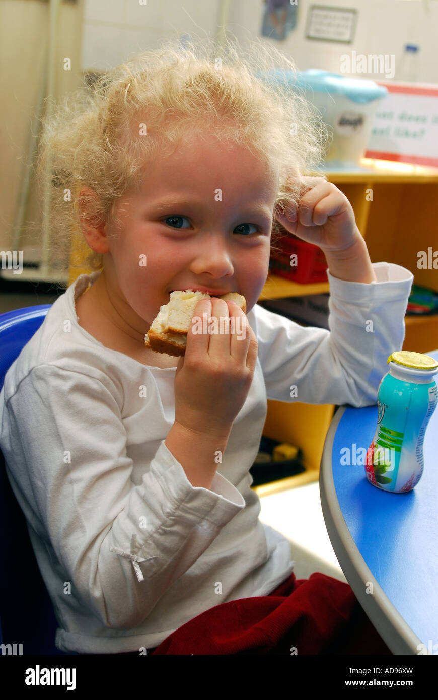 Primary school pupil eating her lunch at school Brentford UK Stock ...