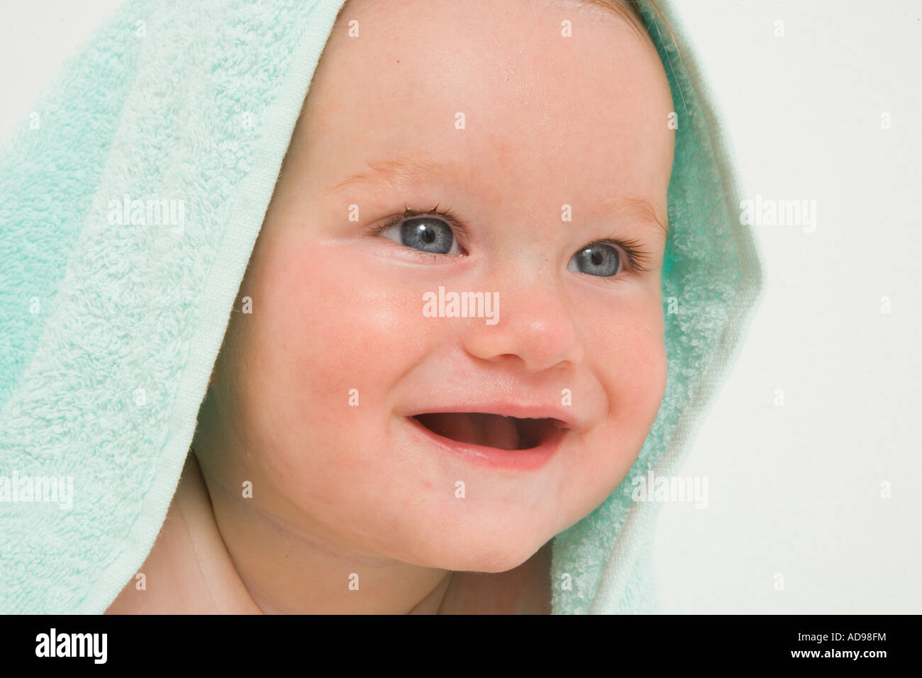 Baby with towel over head hi-res stock photography and images - Alamy