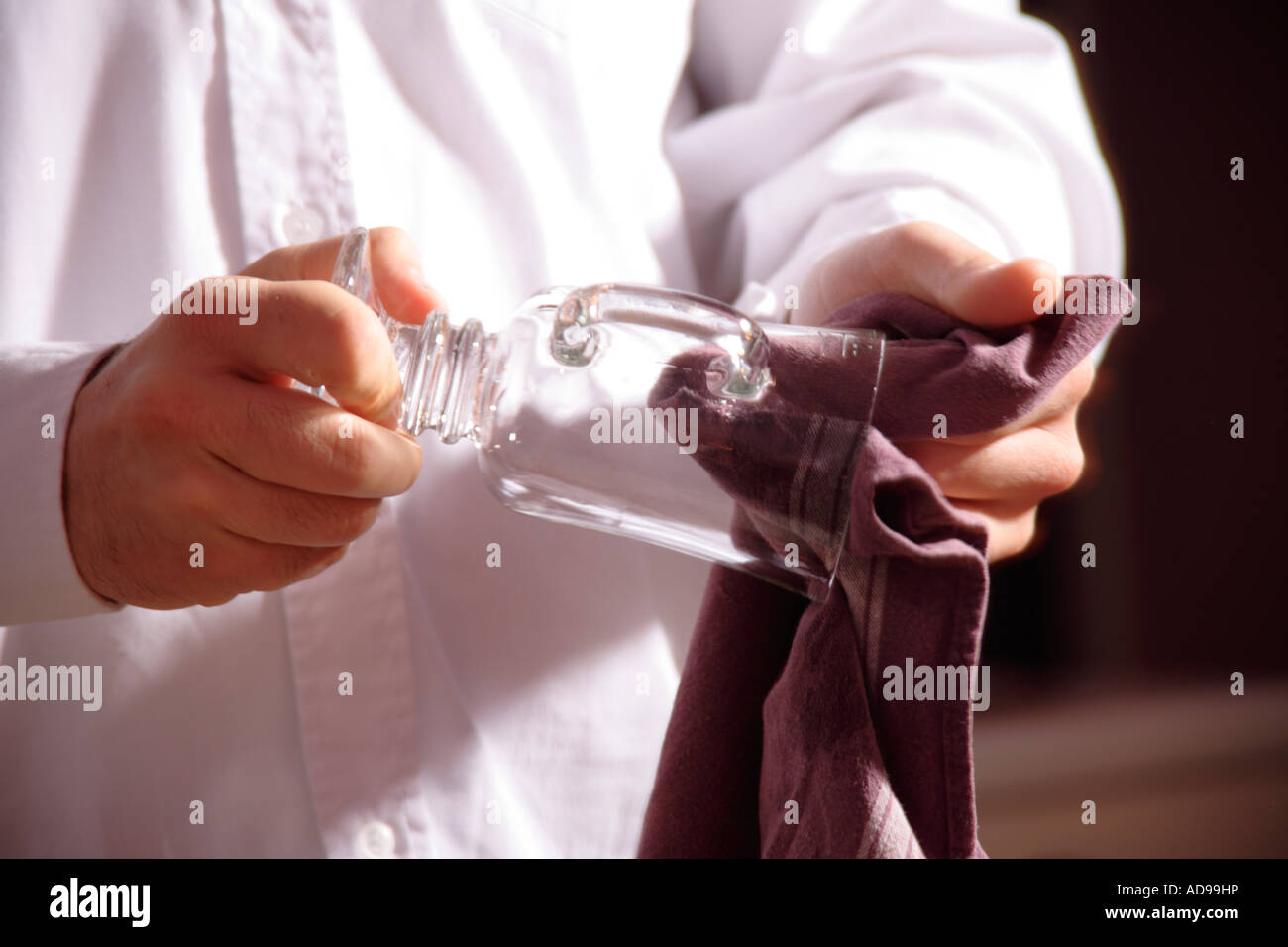 Male hands drying glass, close up Stock Photo - Alamy