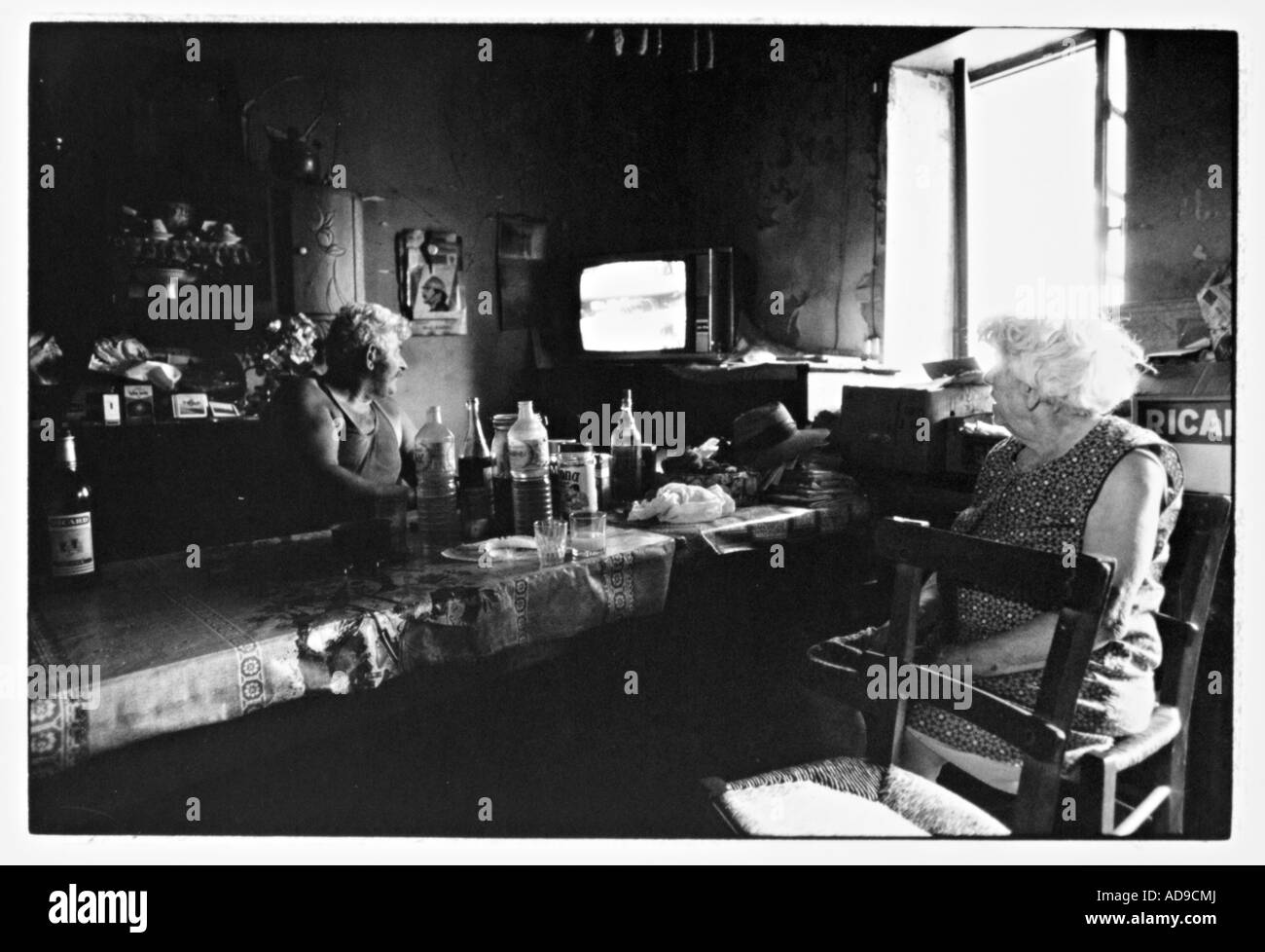 no MR street photography old couple having a meal in front of TV in a ...