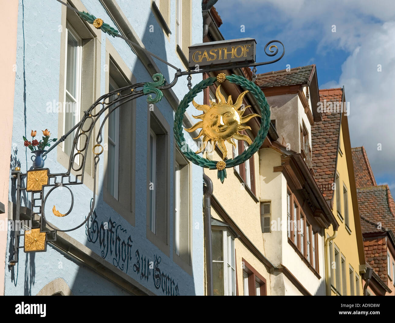 wrought iron shield with golden sun for a guest house in old town of ...