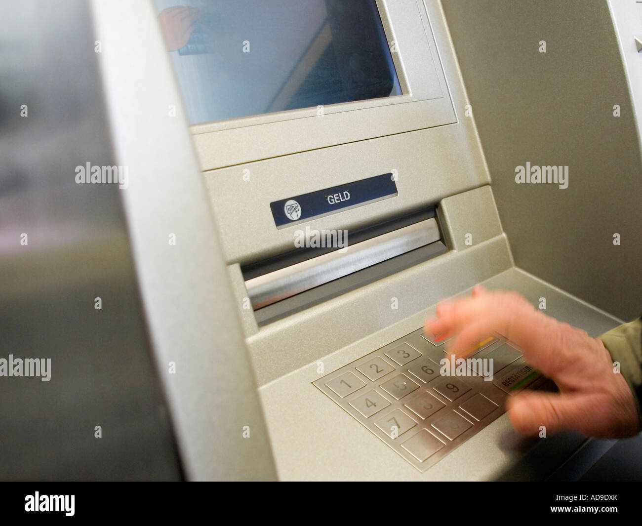 typing the secret code into a ATM automated teller machine Stock Photo ...
