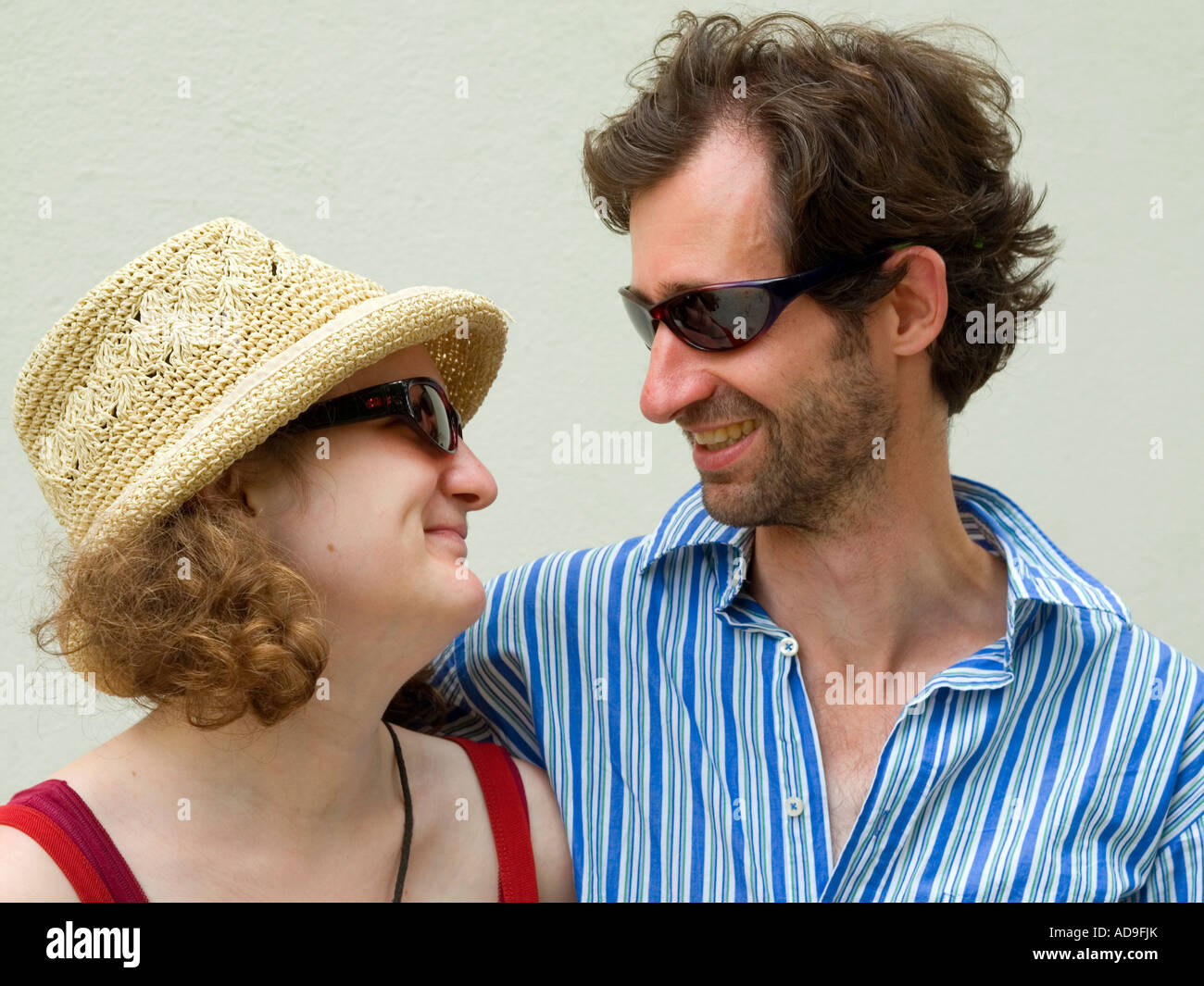 enamoured couple with sunglasses laughing Stock Photo - Alamy