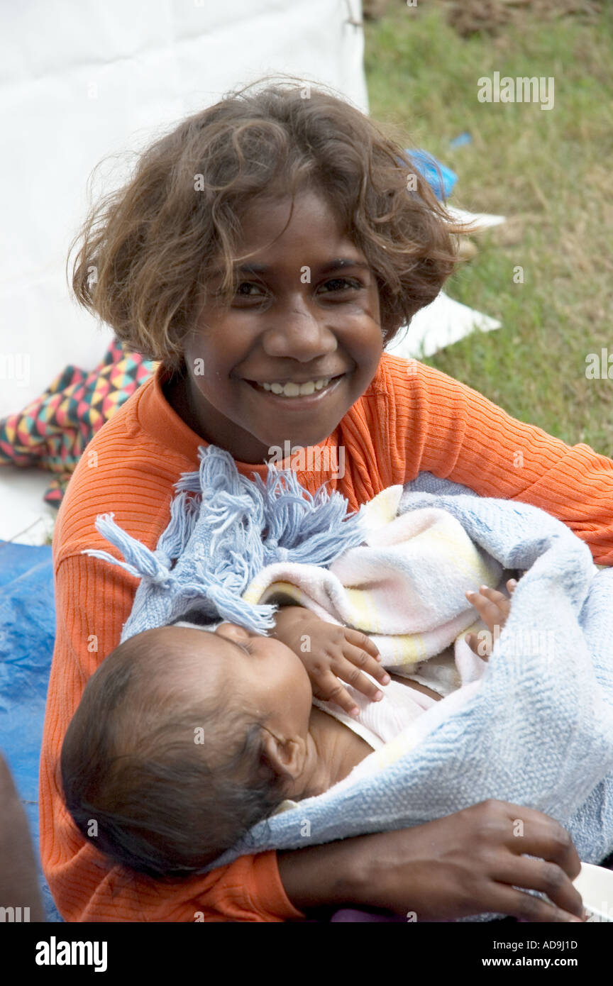 young Aboriginal girl holds baby wrapped in a blanket Stock Photo - Alamy