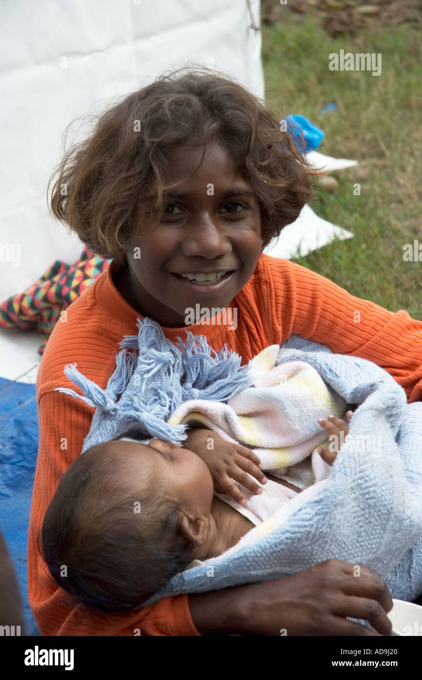 young Aboriginal girl holds baby wrapped in a blanket Stock Photo - Alamy
