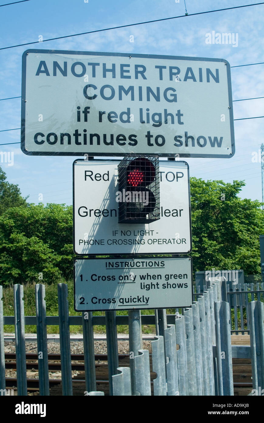 Signs at a rural level crossing at the intersection of a country lane ...