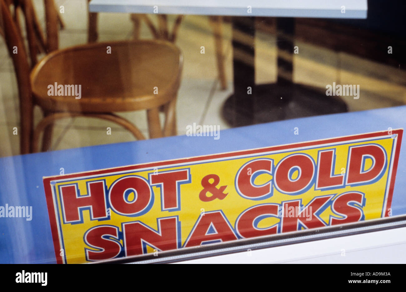 Window of a cafe or diner or restaurant with chairs and table visible ...