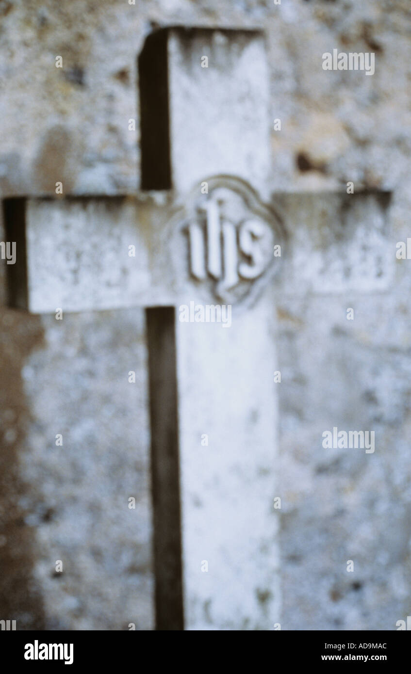 Close up of grey stone grave crucifix bearing the Greek inscription ihs ...