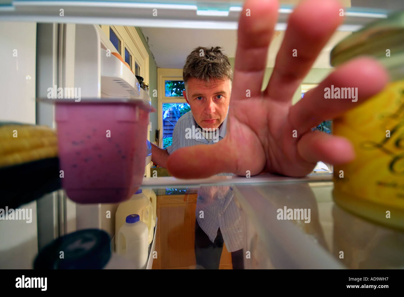 Man reaching into refrigerator hi-res stock photography and images - Alamy