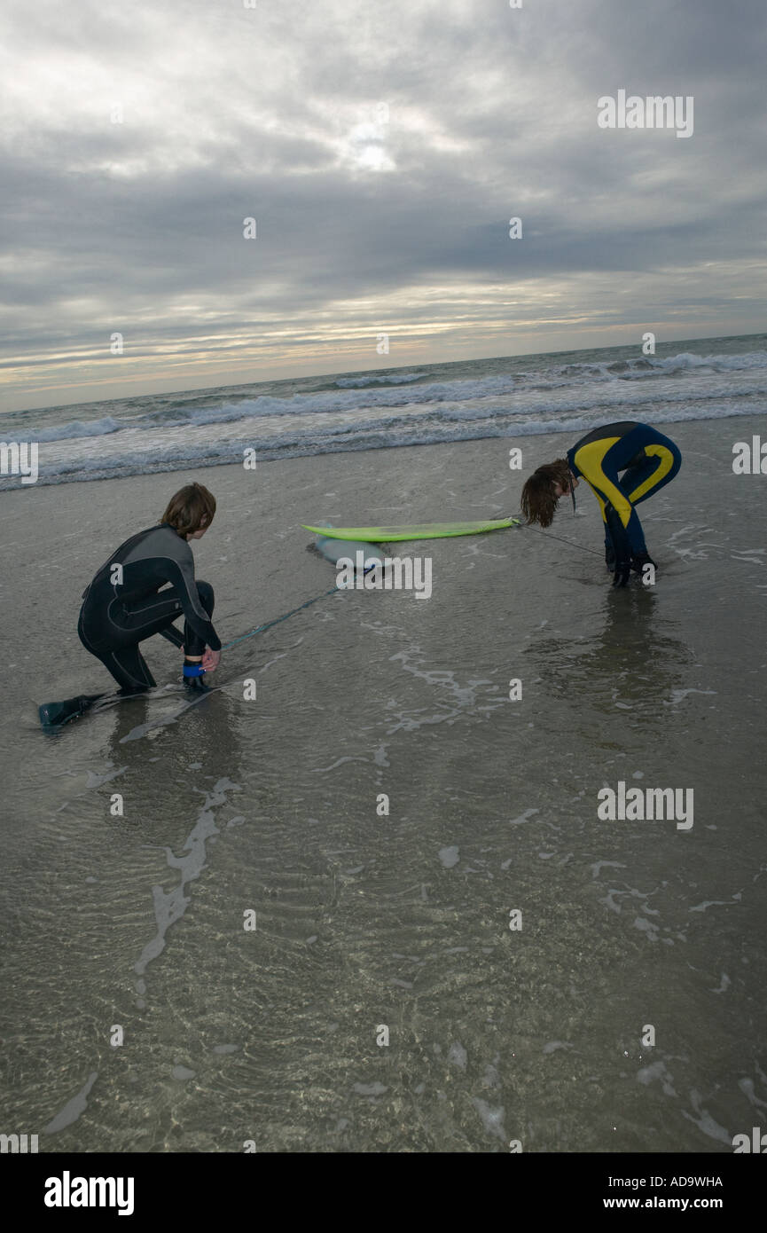 Two young surfers preparing themselves to surf Stock Photo - Alamy