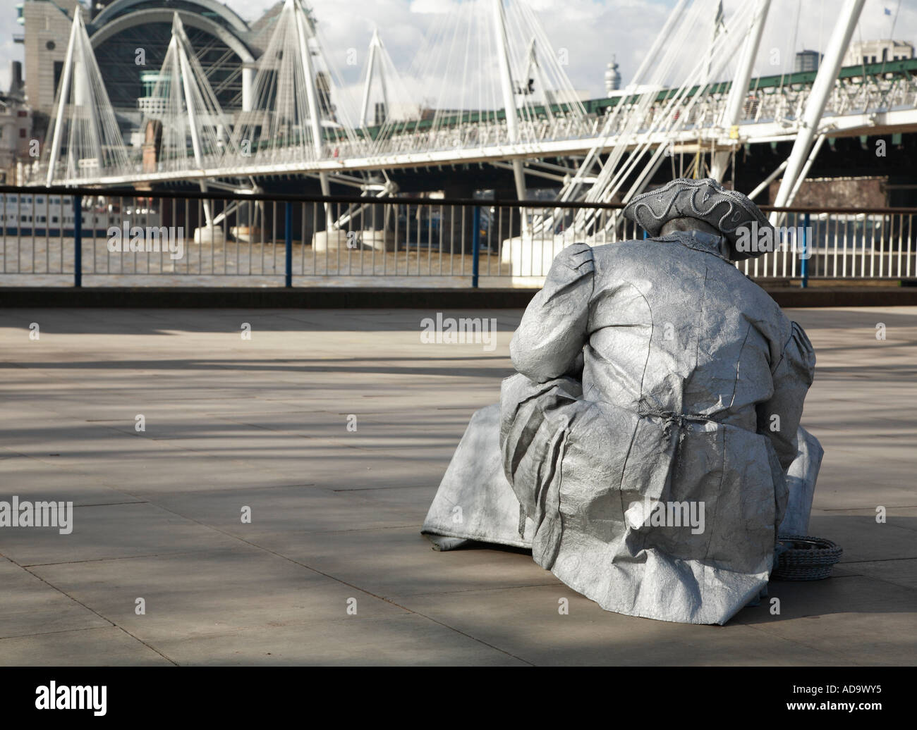 Silver painted human statue prepares for work on South Bank Stock Photo ...