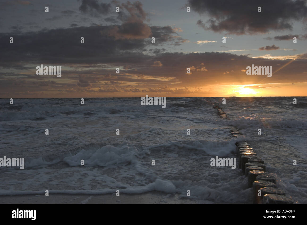 Cloudy sky at beach with spur dikes hi-res stock photography and images ...