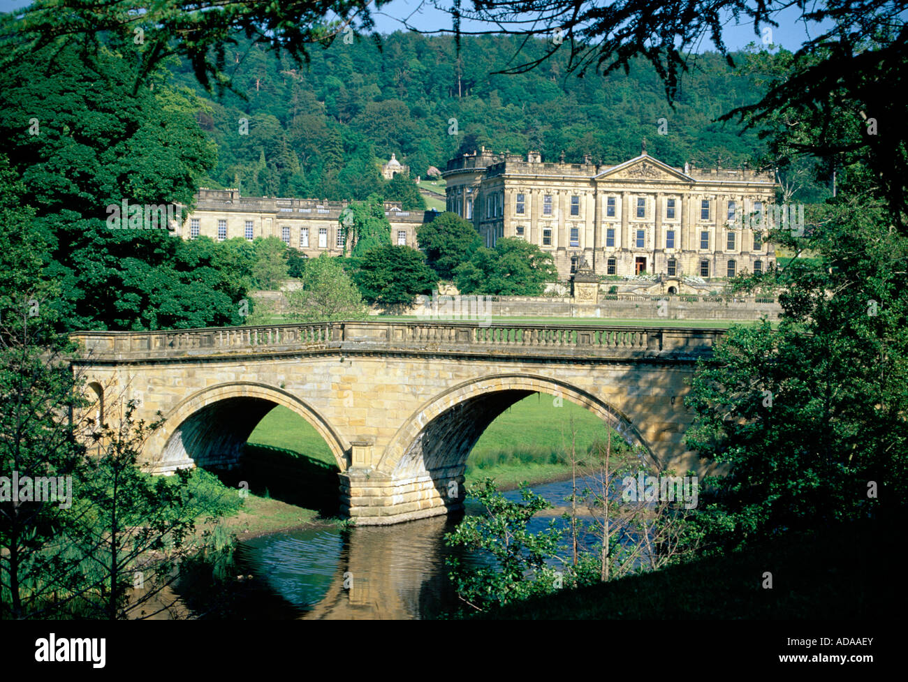 Exterior of Chatsworth House with bridge and garden Derbyshire England ...