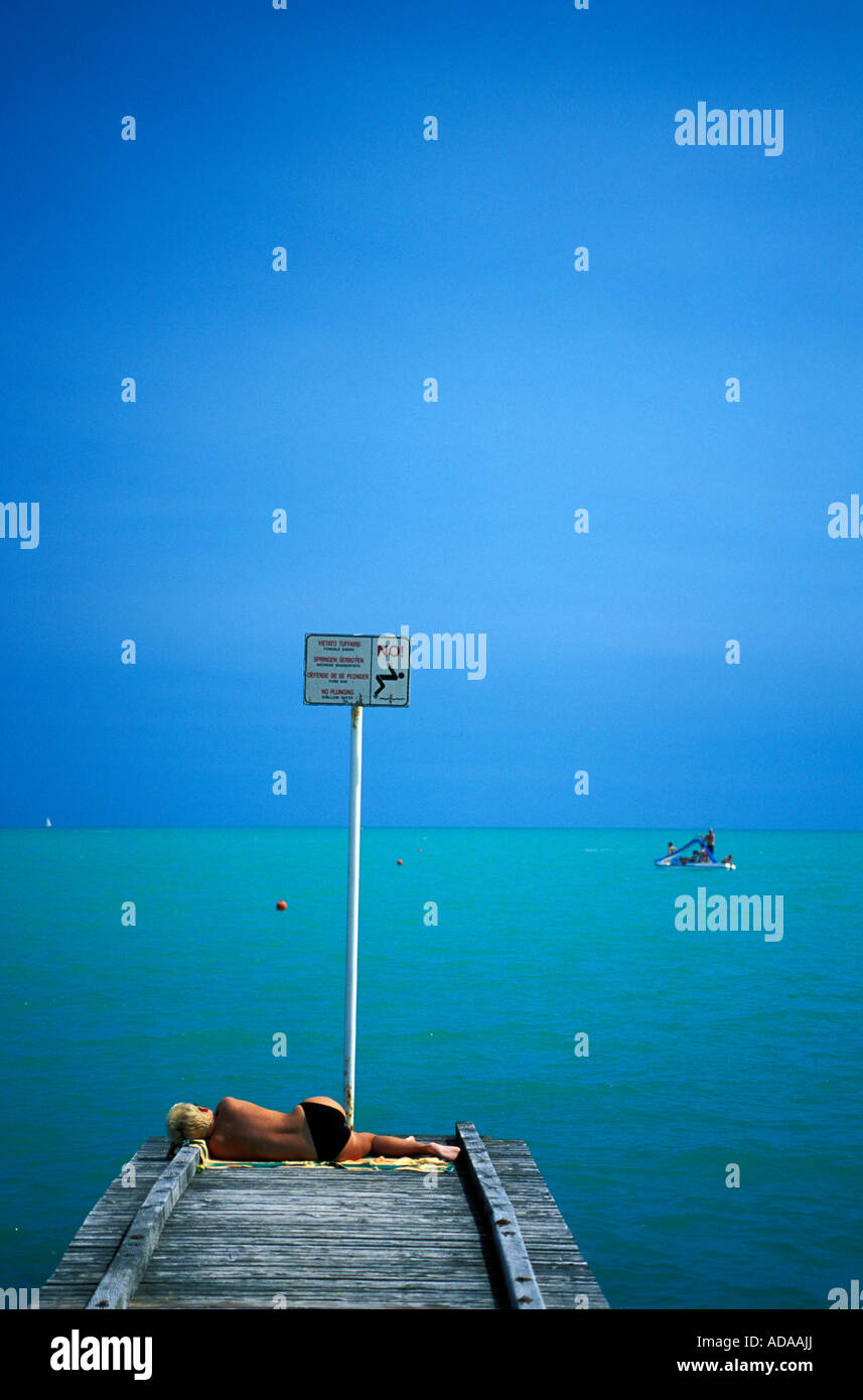 Woman sunbathing on a jetty Adriatic Coast Lido de Jesolo Venice Italy ...