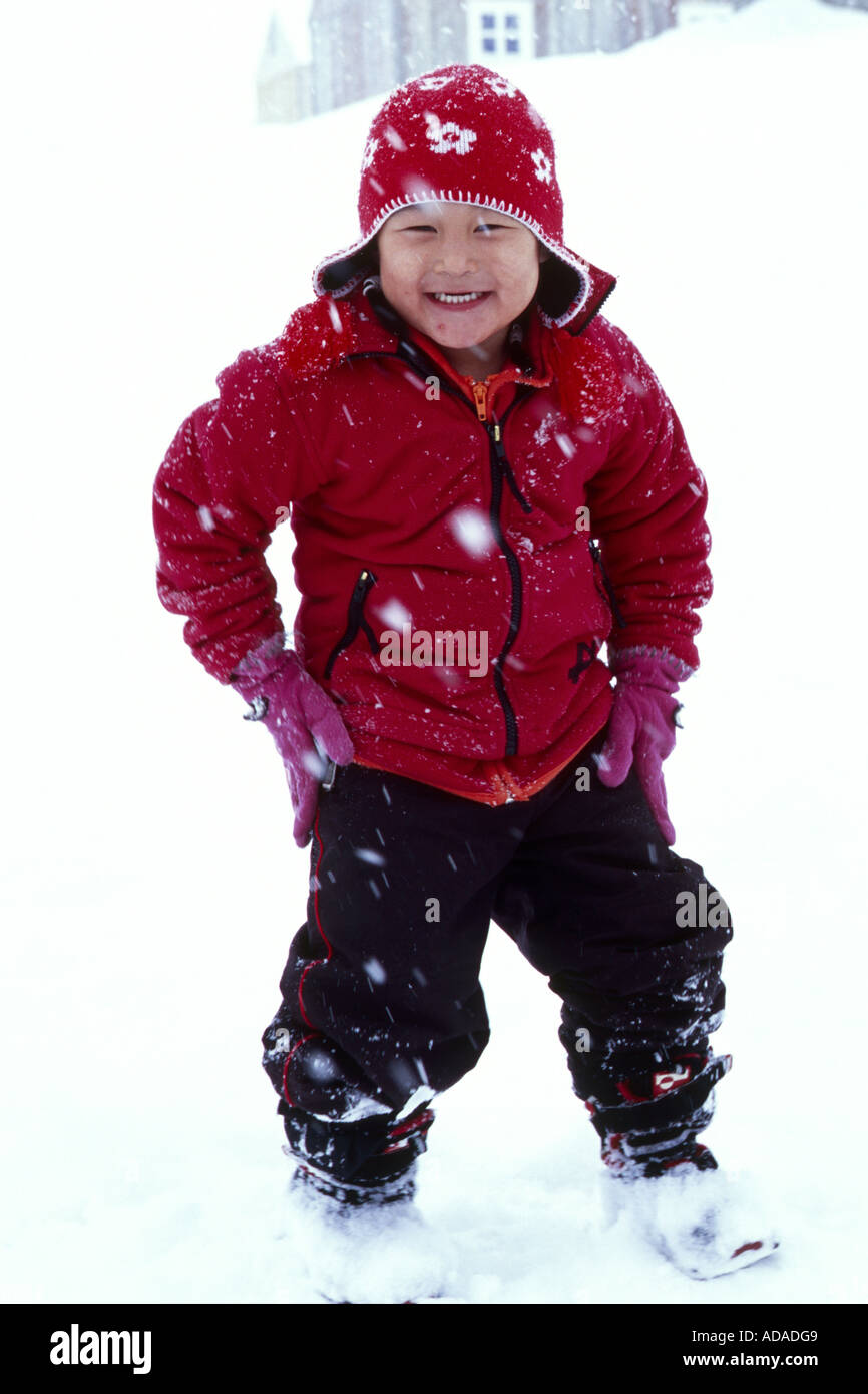 Inuit child is playing in the snow, Greenland, Ammassalik, Angmagssalik ...