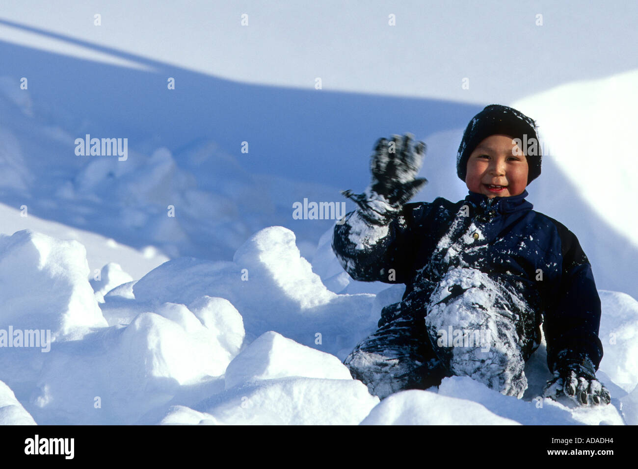 Inuit child is playing in the snow, Greenland, Ammassalik, Angmagssalik ...