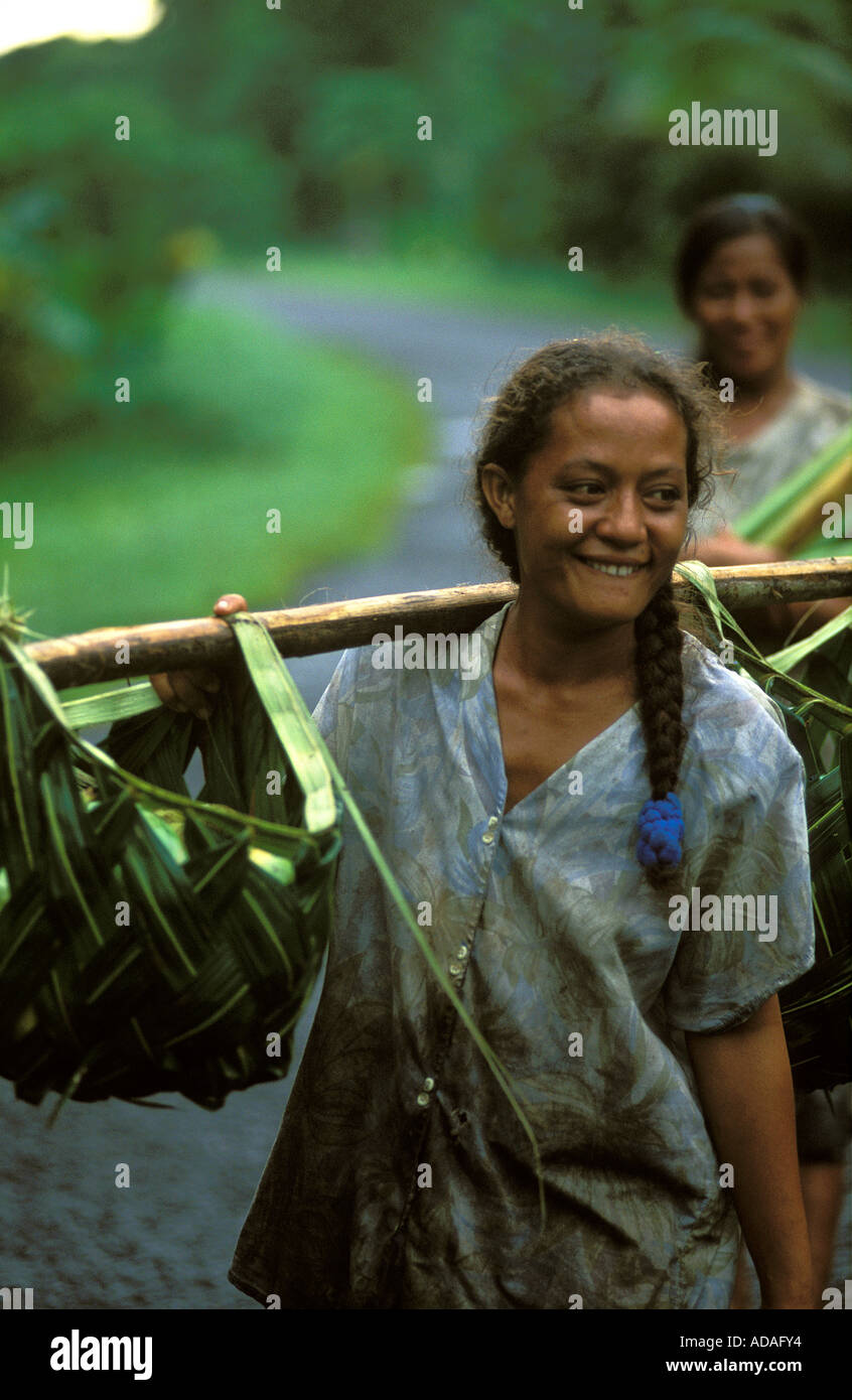 Samoa a young woman carrying baskets on a yoke Stock Photo - Alamy