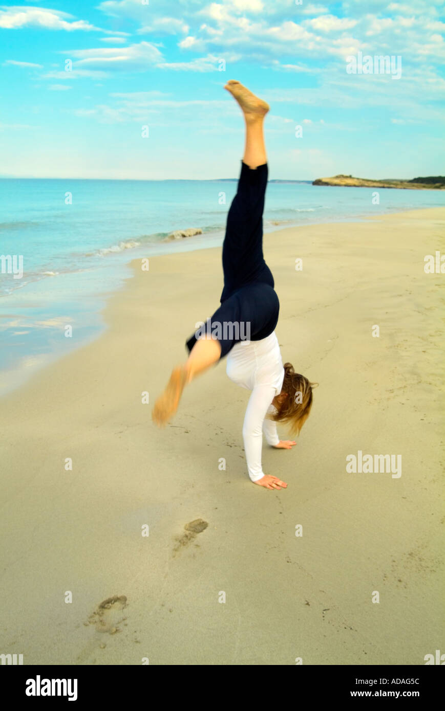 Woman beach cartwheel hi-res stock photography and images - Alamy