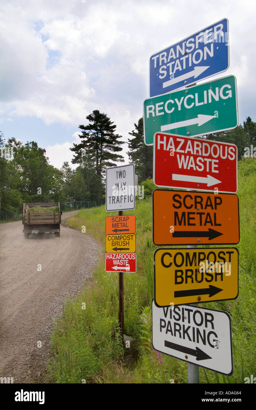 Signs at a recycling center point the directions to various recycling ...