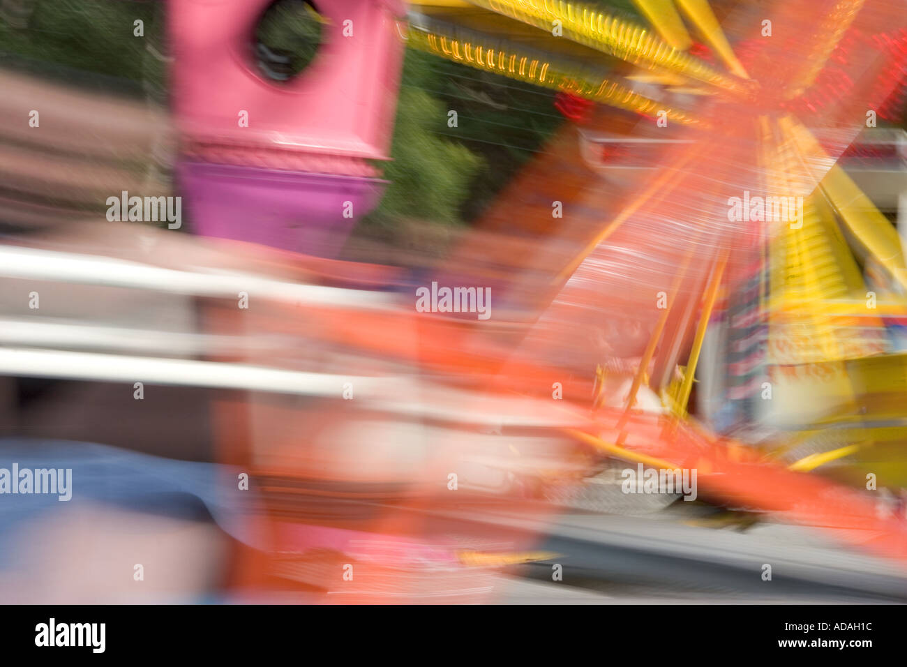 Twist ride passengers at amusement park fairground riders or travelling ...