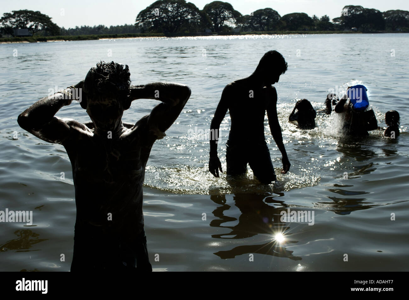 Kataragama buddhist pilgrims taking a bath in the Tissa Wewa lake ...