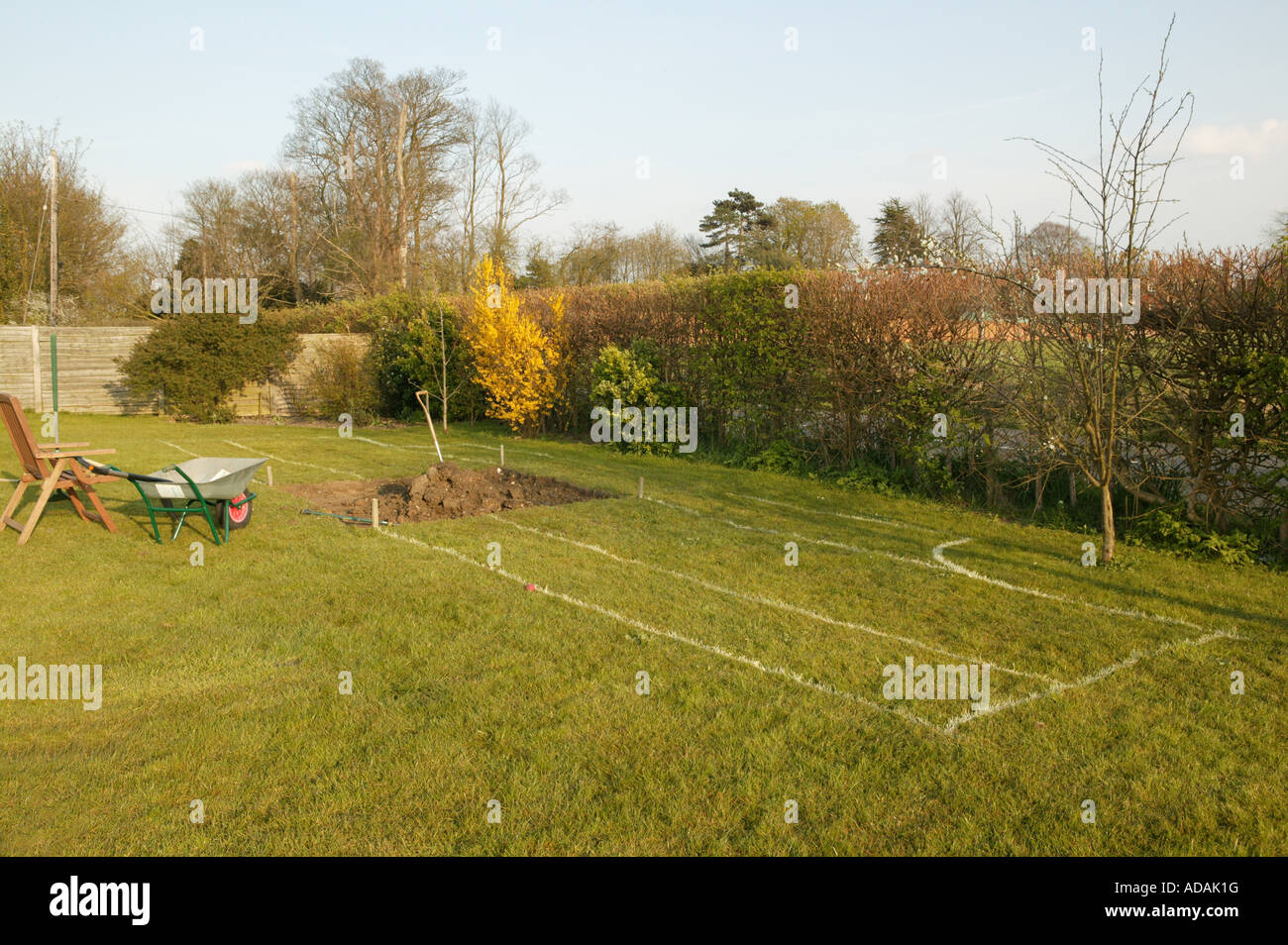 Garden design project illustrated by painted lines on the garden lawn ...