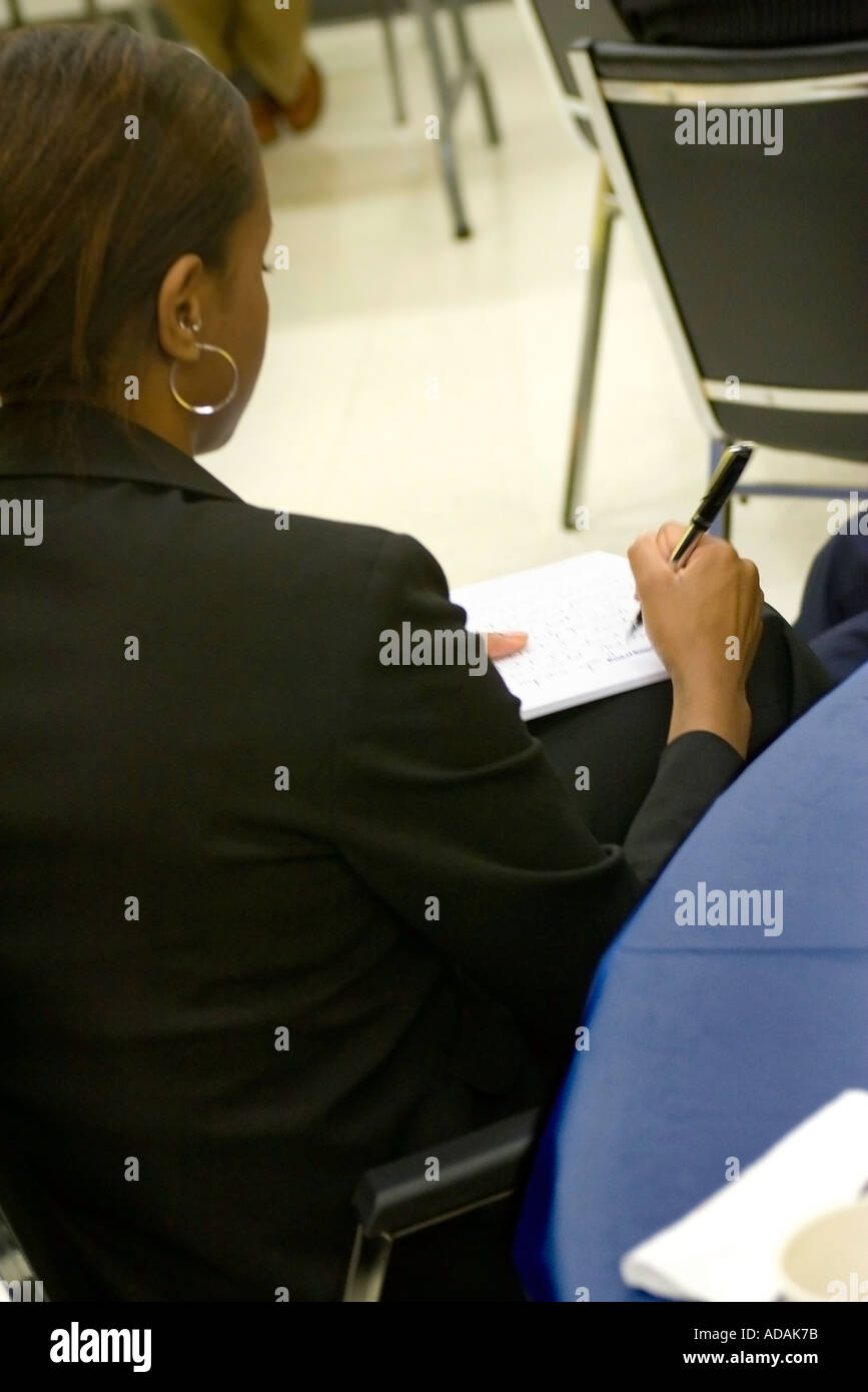 Woman taking notes in conference meeting Stock Photo - Alamy