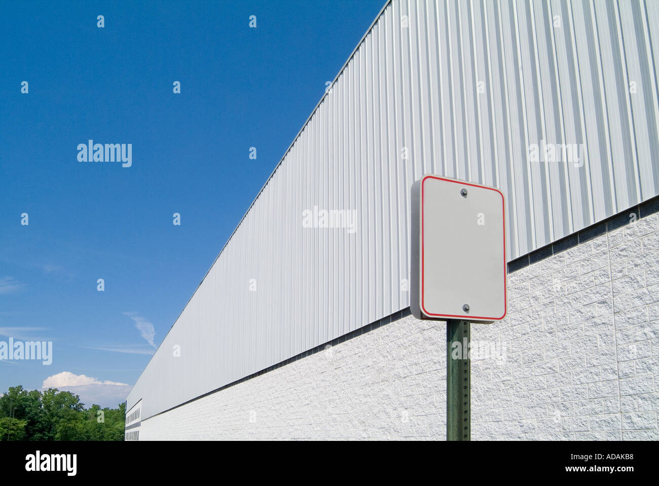 Blank sign outside white building Stock Photo - Alamy
