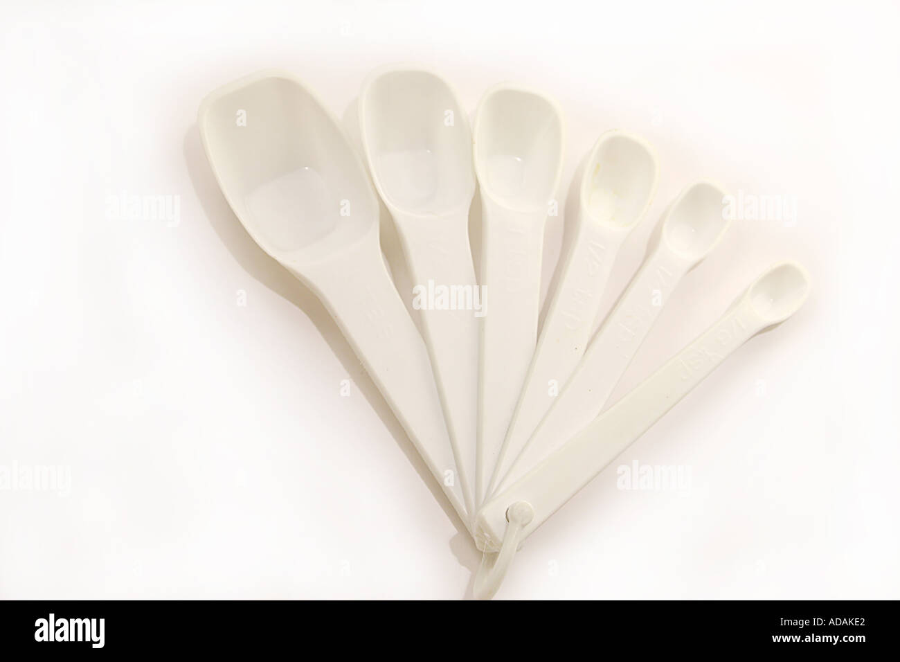 White Measuring Spoons Scoops Kitchen Equipment Stock Photo - Alamy