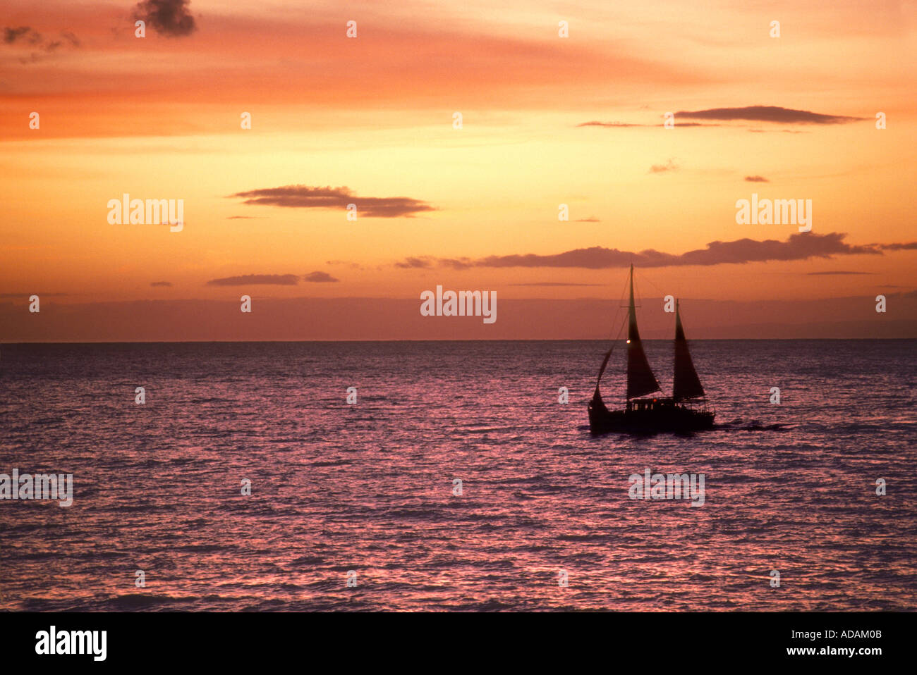 Sailboat at sunset, Hawaii USA Stock Photo - Alamy