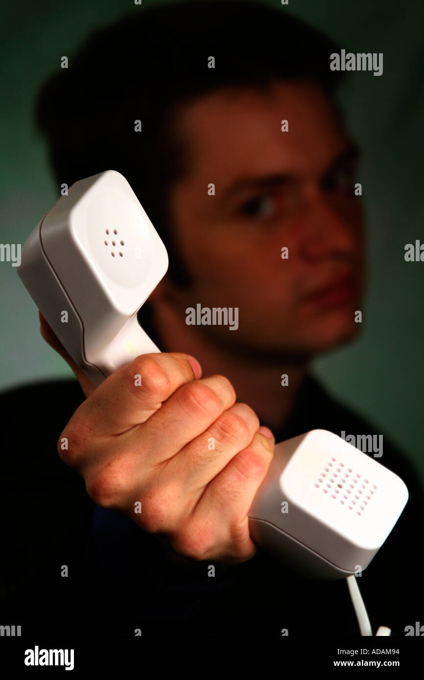 Young Man Handing Over The Phone Stock Photo - Alamy