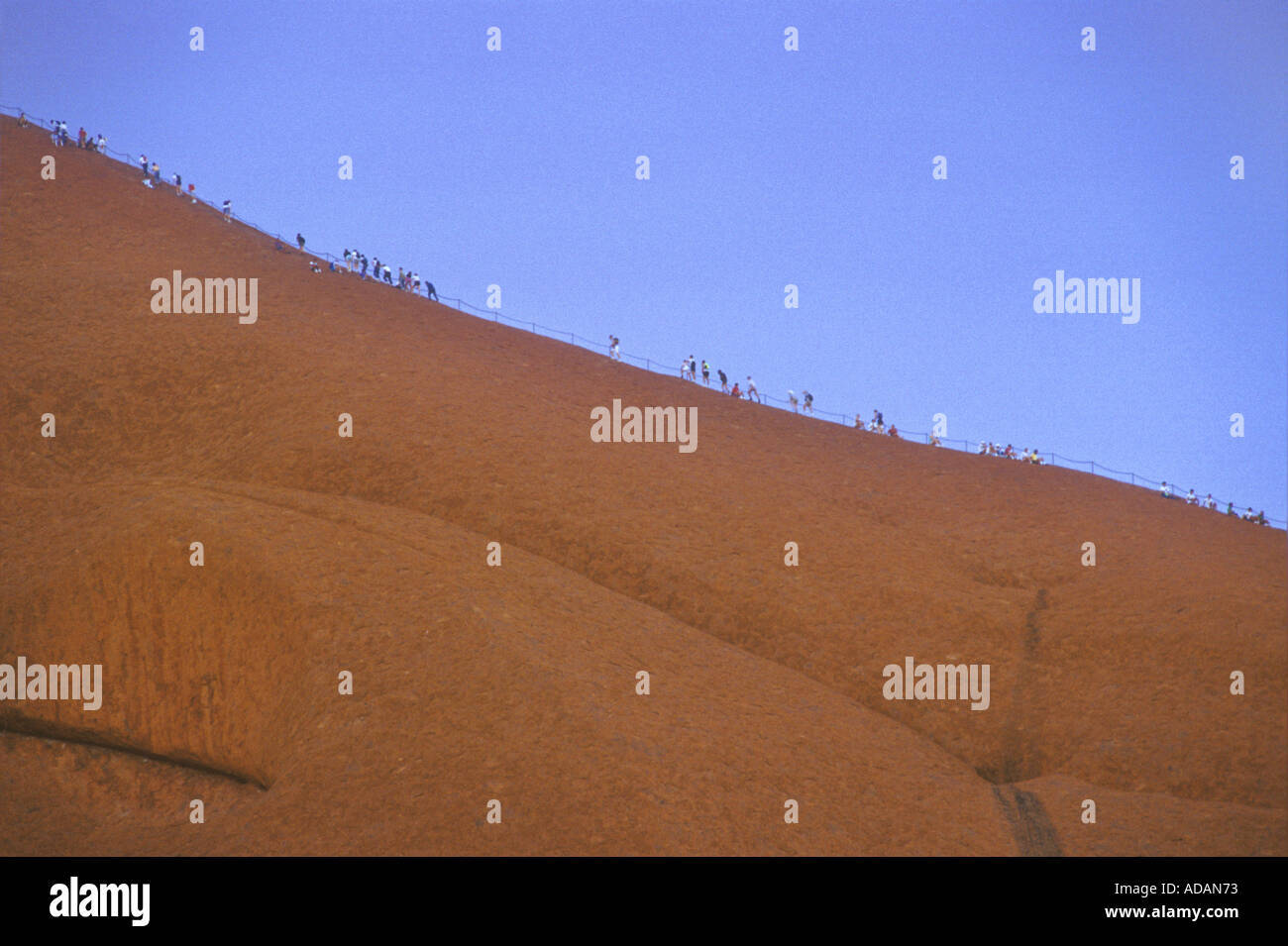Line Of Hikers Climbing Ayers Rock, Australia Stock Photo - Alamy