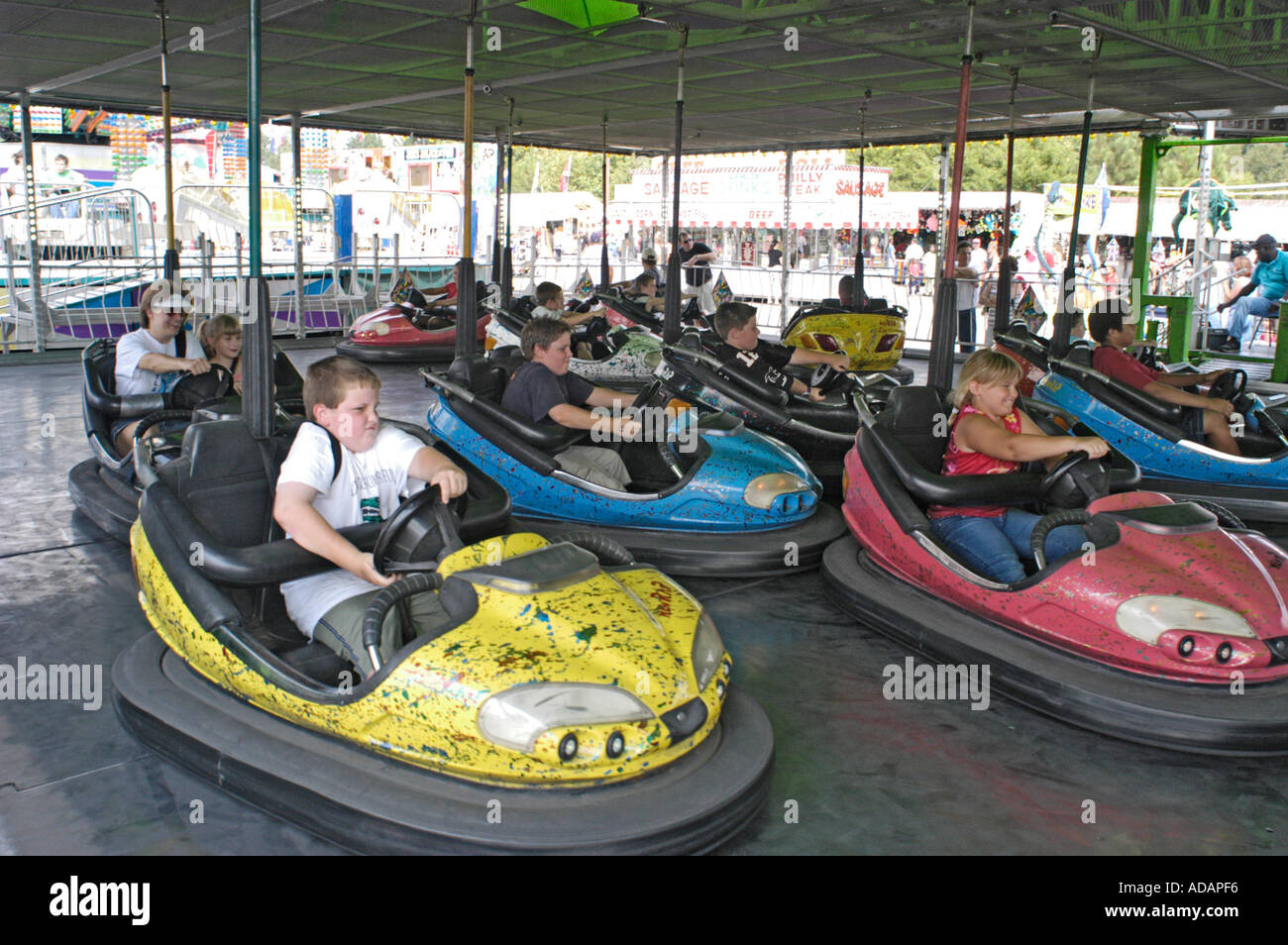 People on local carnival rides for fun during summer vacations face ...