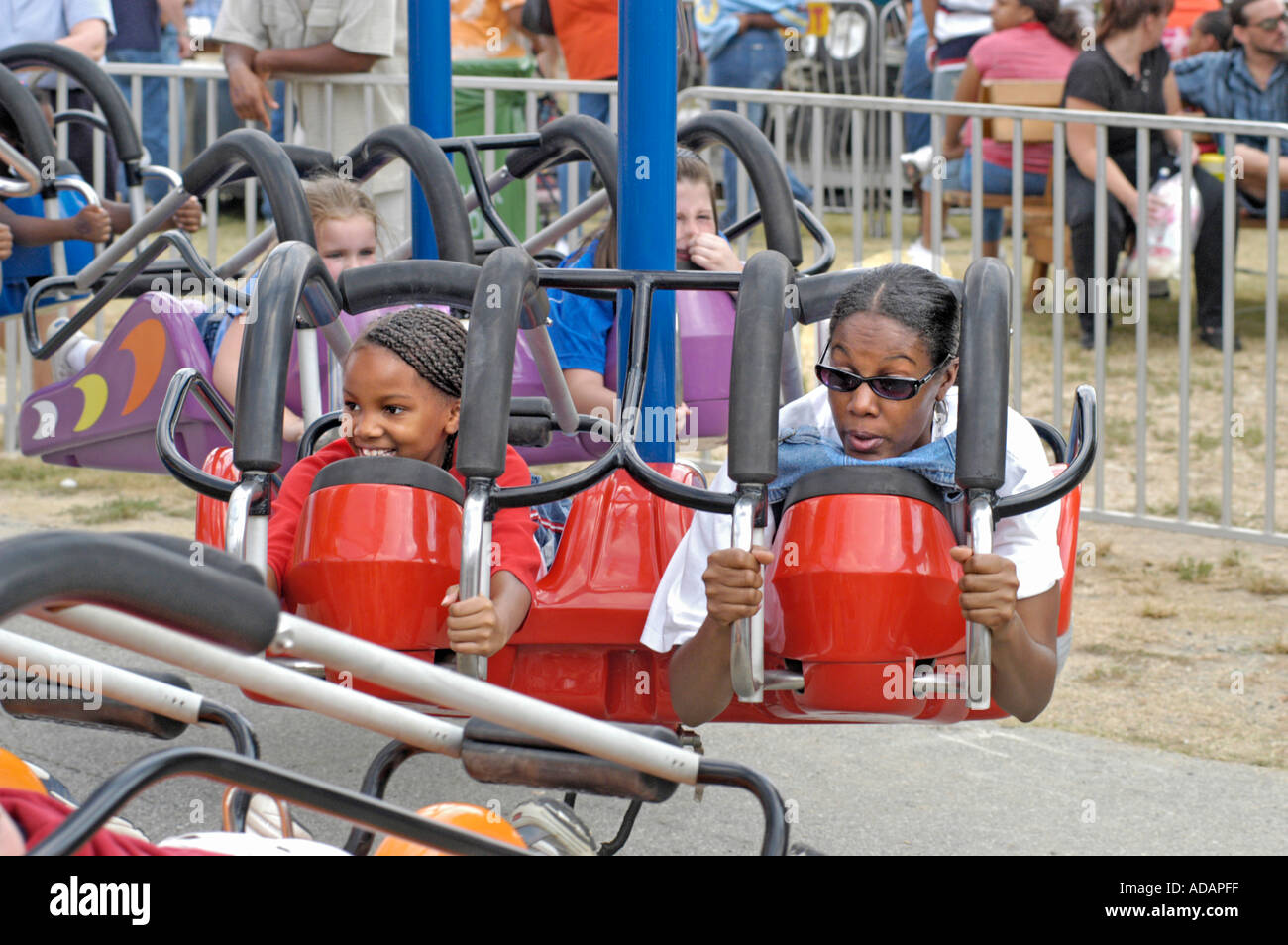 People on local carnival rides for fun during summer vacations face ...