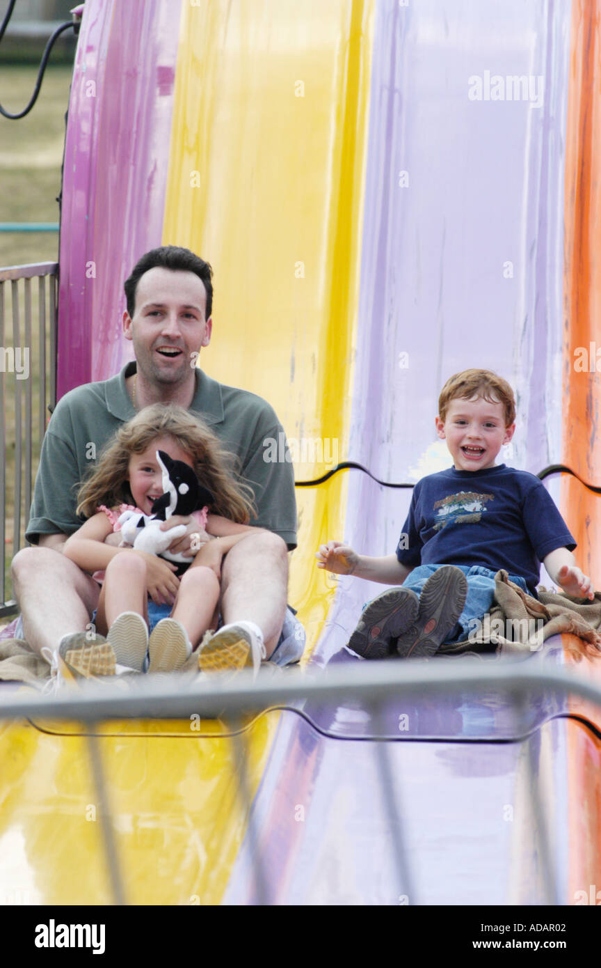 People on local carnival rides for fun during summer vacations face ...