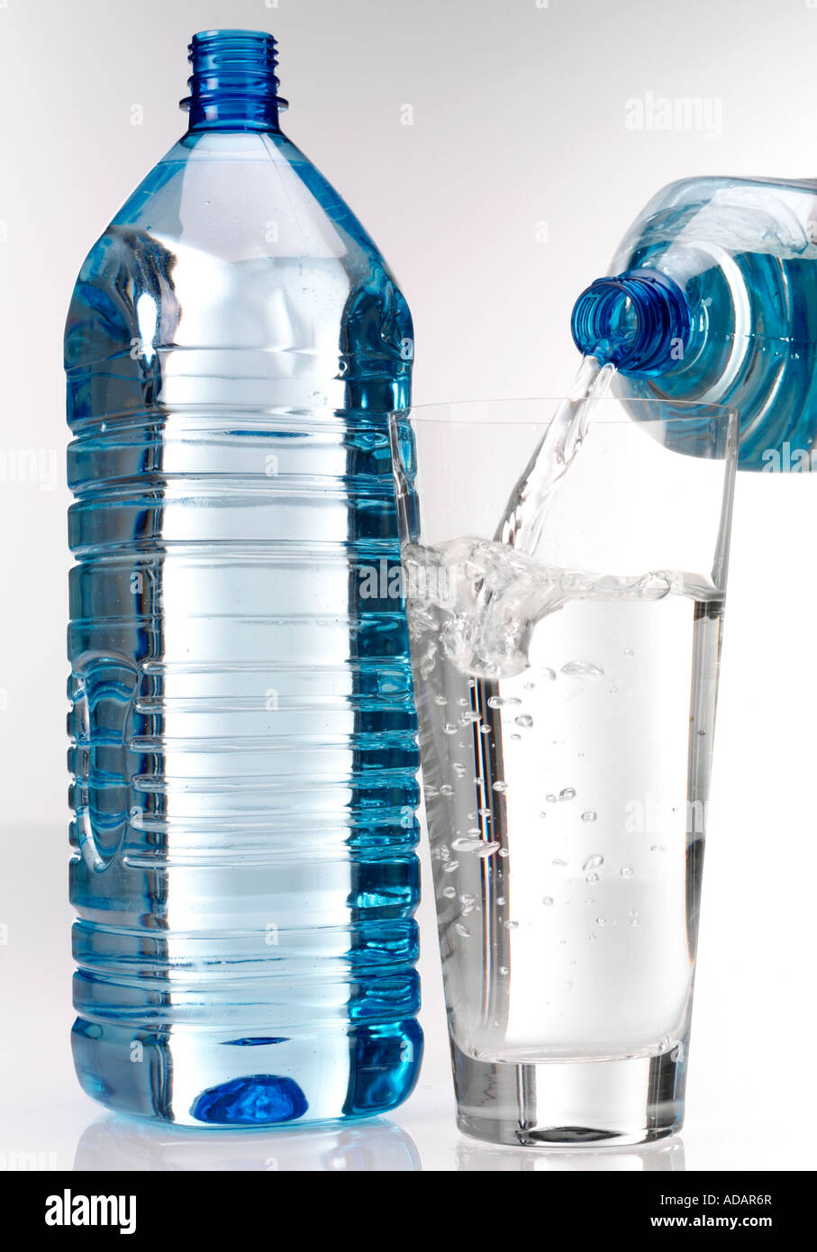 POURING FROM BOTTLE OF WATER Stock Photo - Alamy