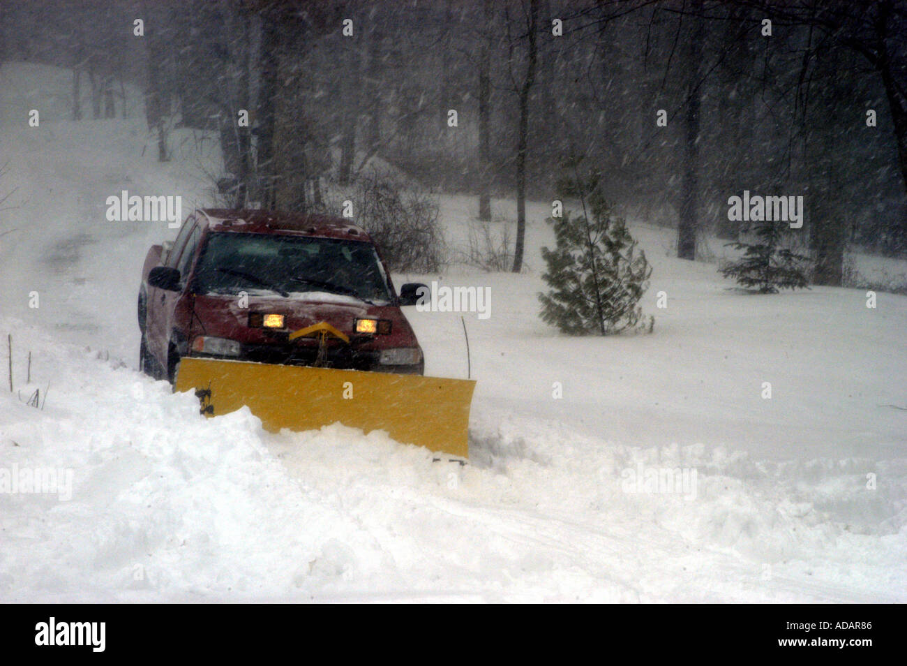 Pickup truck snowplow clearing driveway of snow Stock Photo - Alamy