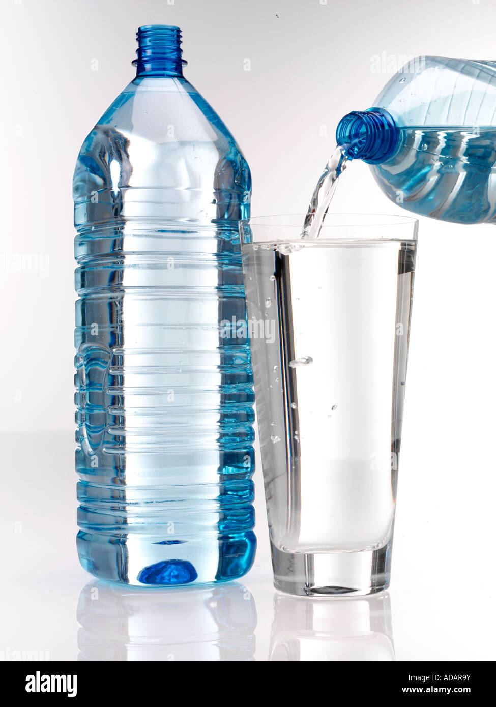 POURING FROM BOTTLE OF WATER Stock Photo - Alamy