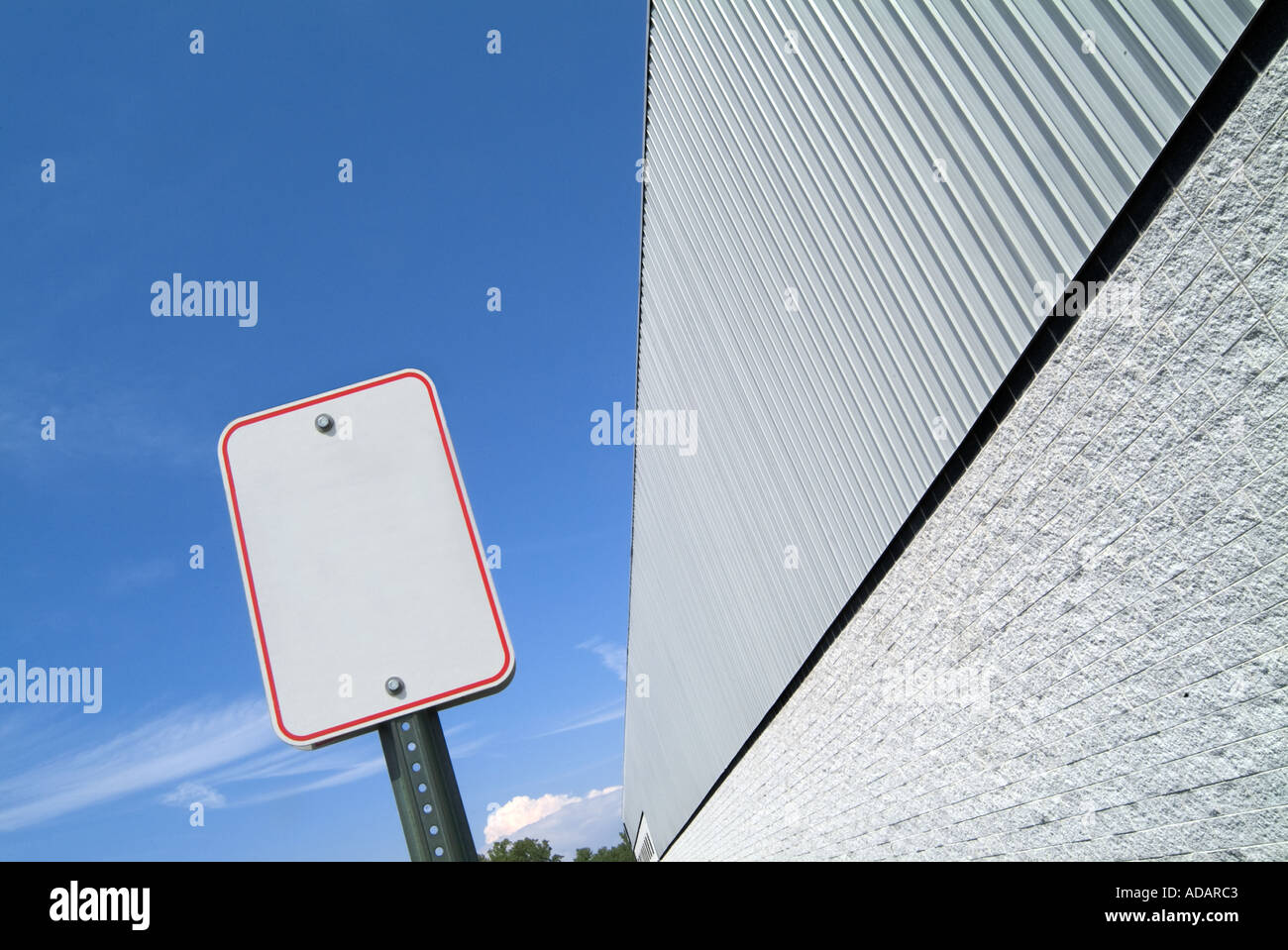 Blank sign outside white building Stock Photo - Alamy