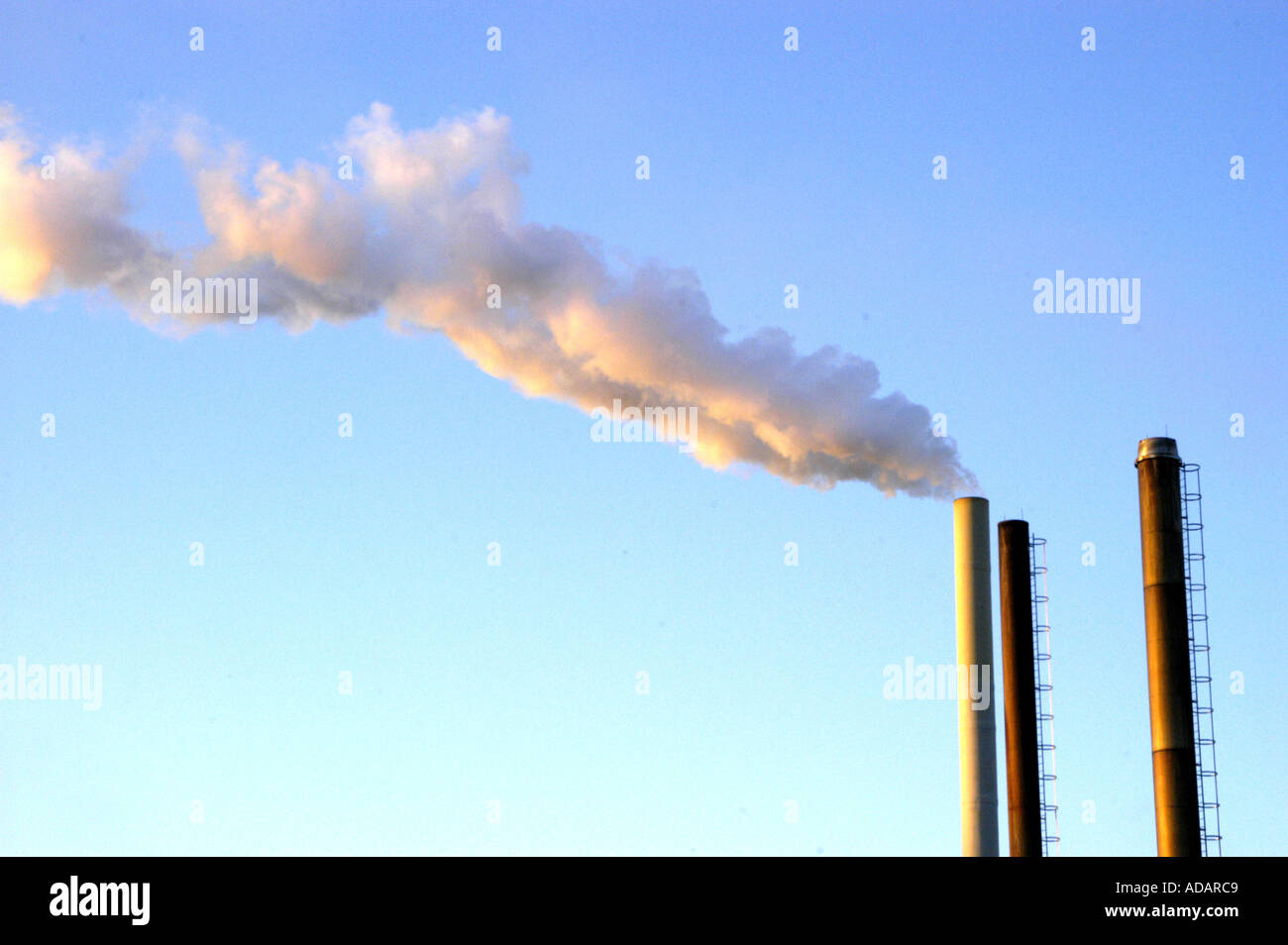 Smokestacks with long smoke plume Stock Photo - Alamy
