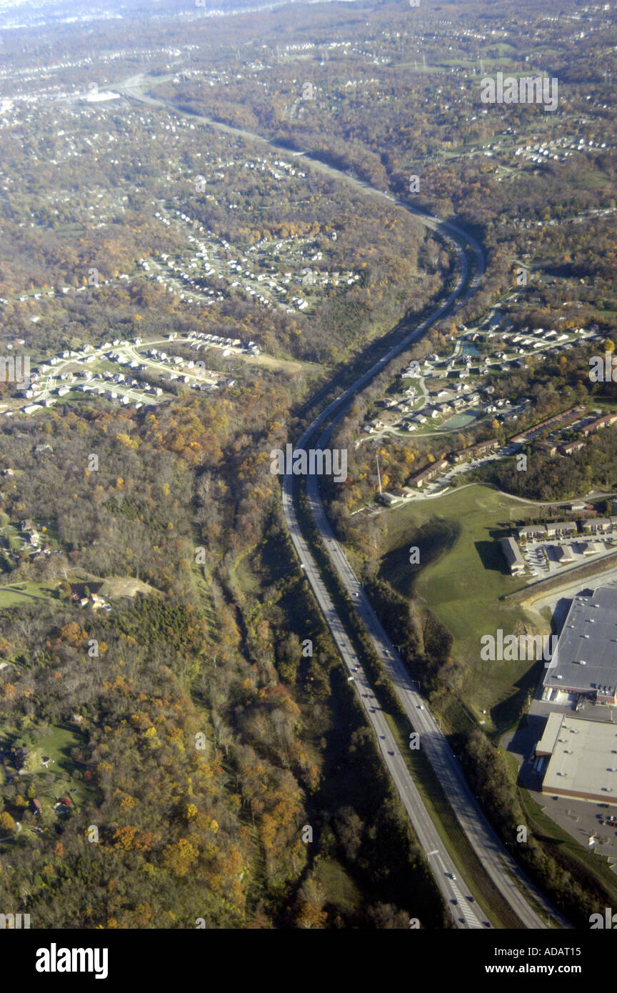 Aerial view of interstate highway in hilly terrain with housing ...