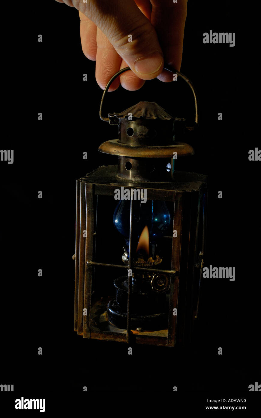 Man's hand holding a burning old-fashioned oil lamp Stock Photo - Alamy