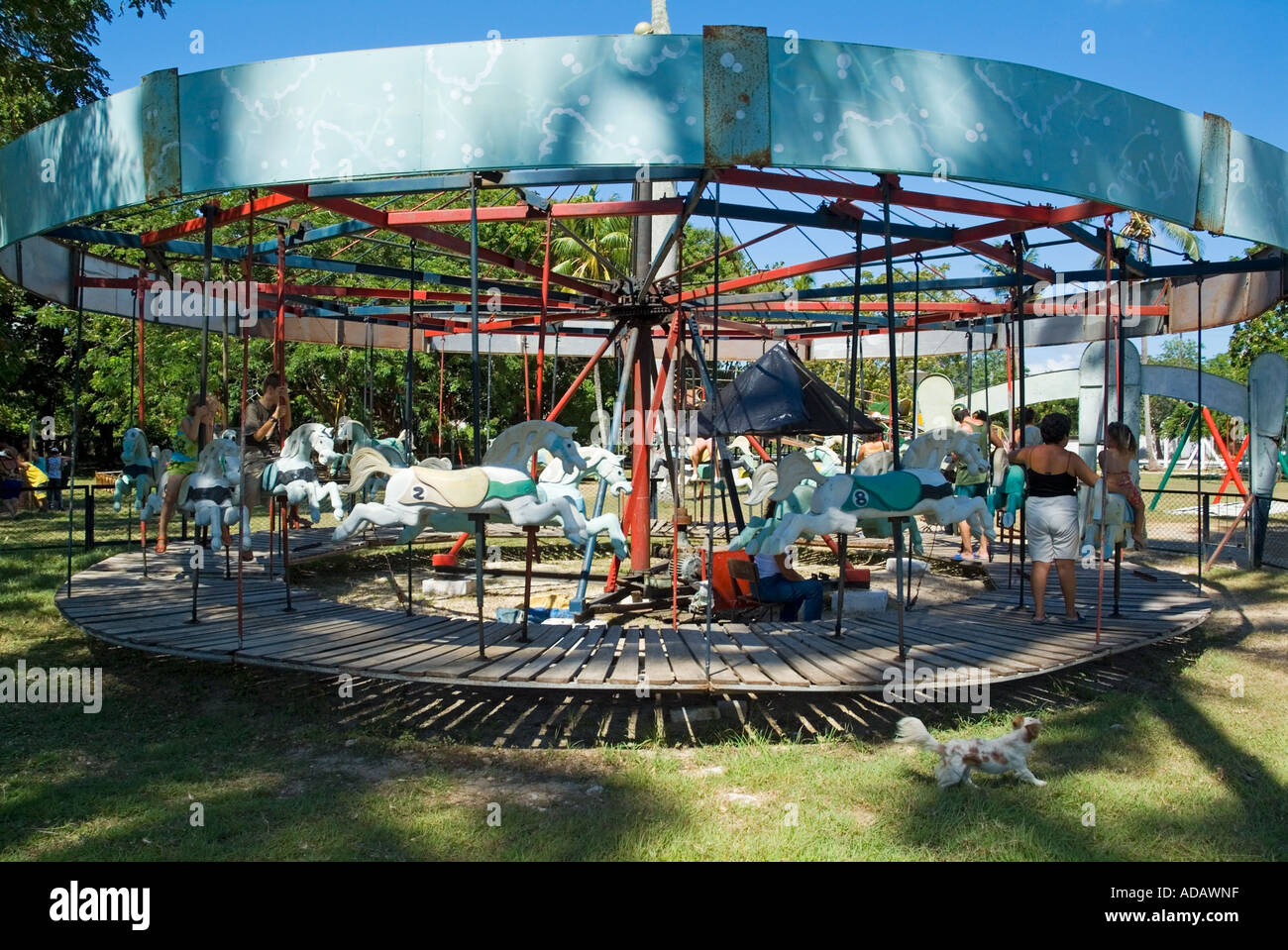 Children riding horses on a merry go round ride in Remedios Amusement ...